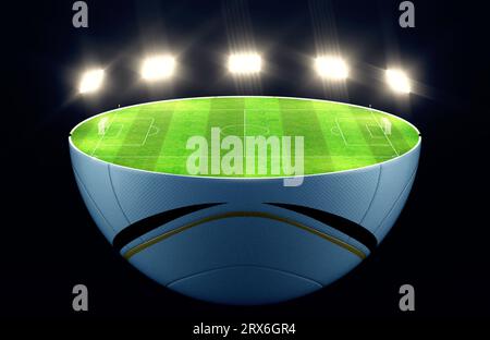 A soccer ball split in half revealing a marked green grass football ...