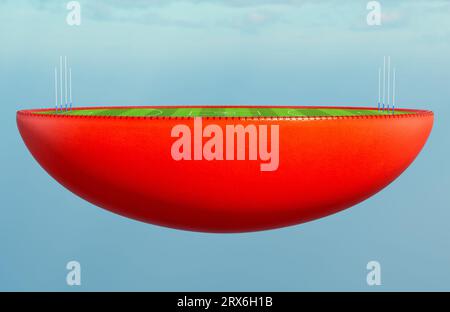 An ausralian rules ball split in half revealing a marked green grass ...