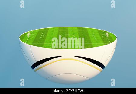 A soccer ball split in half revealing a marked green grass football ...