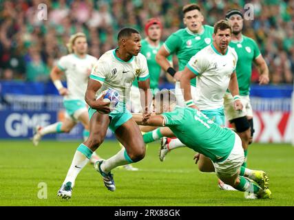 South Africa's Damian Willemse is tackled by Italy's Louis Lynagh ...