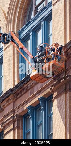 Maintenance crew tends 21 Astor Place, in NoHo, an 1892 office building and NYC landmark ...