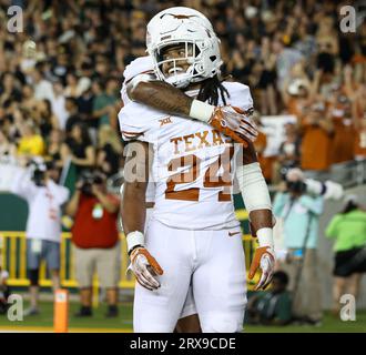 Texas running back Jonathon Brooks, center, is stopped by Kansas State ...