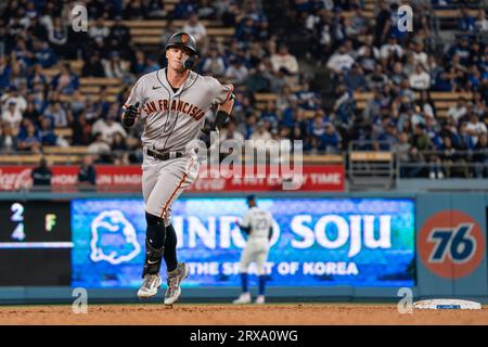 San Francisco Giants' Tyler Fitzgerald, left, hands his batting helmet ...