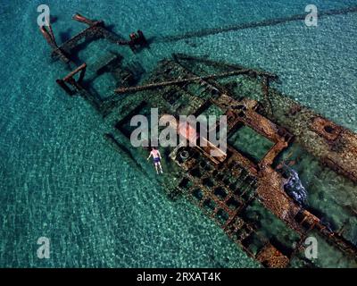 Greece, People dive into the crystal clear waters of the Mediterranean ...