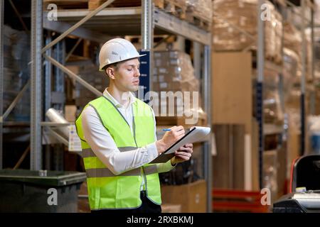 confident male worker doing stocktaking of product management on ...