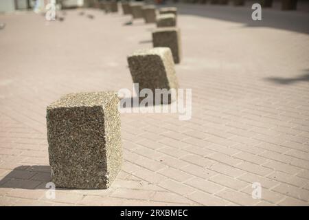 Parking poles. Fence from cars on pavement. Stone obstacles in city ...