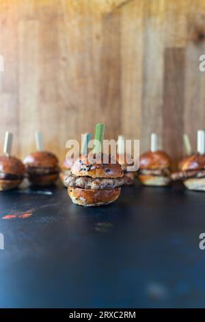 Burger mini burgers snacks on a wooden table with craft paper ...