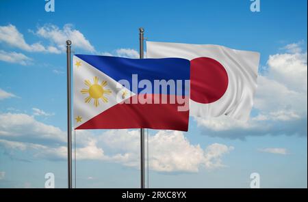 Philippines and Japan flag waving together in the wind on blue sky, two ...