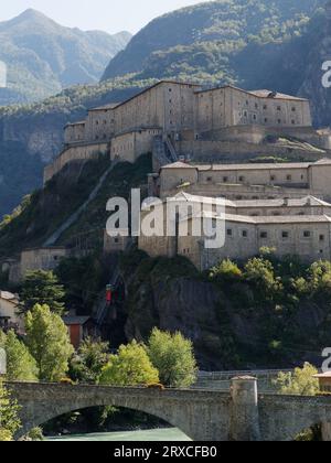 Forte di Bard (Fort of Bard) with alps behind and with bridge over the ...