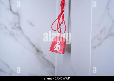 Red emergency pull cord in a disabled toilet Stock Photo - Alamy
