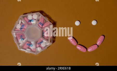Organizer weekly shots with smile made of tablets for daily take ...