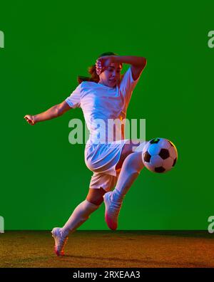 Knee kick. Young professional female football, soccer player in motion ...