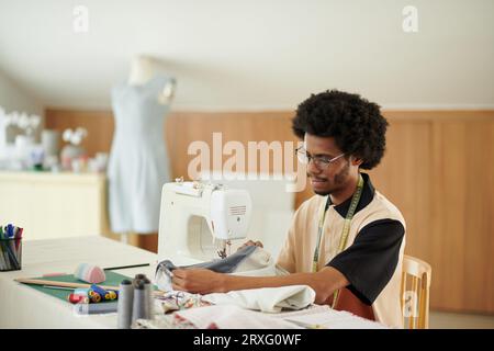 Woman working on dress design in a clothing studio with many dresses ...