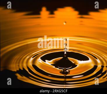 Falling oil drops with oil rings Stock Photo - Alamy