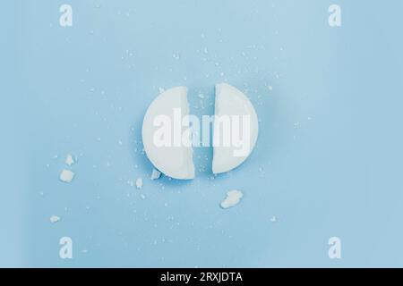 Pill broken on half. Pharmacy medicament concept Stock Photo - Alamy