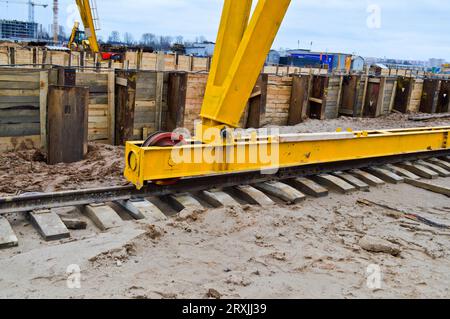 Large iron metal yellow supports on rails with wheels with an induction ...