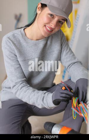 female electrician installing electric device in ceiling Stock Photo ...