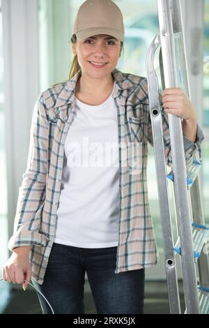 Construction worker carrying ladder at renovating object Stock Photo ...