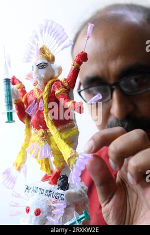 Samiran De, an artist works on an idol of Lord Ganesha made with soup ...