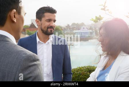 young businesspeople looking at each other and talking at the office ...