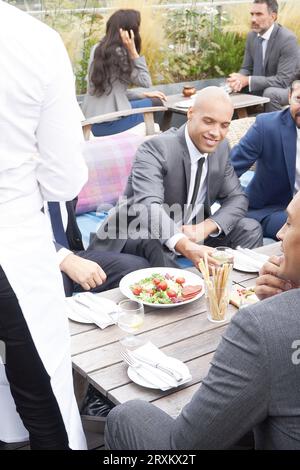 Businessman smiling during restaurant meeting Stock Photo - Alamy
