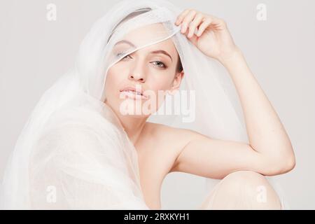 Young woman wrapped in sheer sheet Stock Photo - Alamy