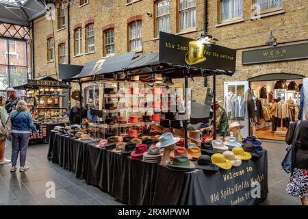 People browsing a hat stall at Old Spitalfields Market, London E1 Stock ...