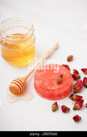 Handmade solid shampoo with honey and dry flowers on light background ...