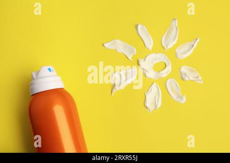 Drawing of sun and bottle with sunscreen on orange background, top view ...