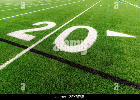Synthetic turf football field twenty, 20, yard line in white Stock ...