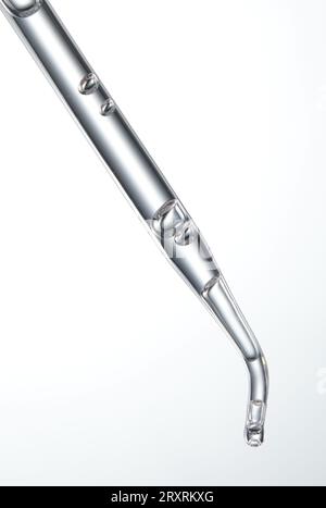 The tip of a glass laboratory tube is dripping a liquid Stock Photo - Alamy
