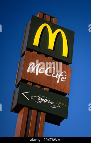McDonald's, McCafe and McDrive logos are seen on a sign above a fast ...