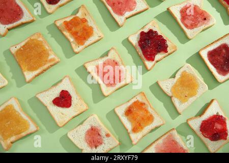 Many toasts with different jams on color background Stock Photo - Alamy