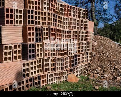 A stack of hollow clay blocks in a construction site, in a farm in the ...