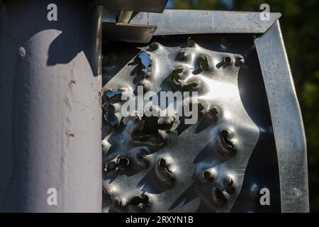 Metal shield shot from shotgun shot, exit holes in the metal Stock ...