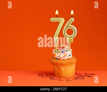 Birthday card - Number 76 candle in orange background Stock Photo - Alamy