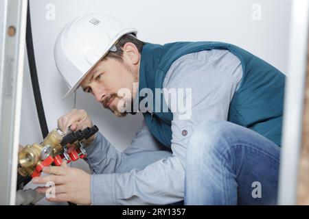 Professional Plumber Checking Water Valves in the Pipes of the ...