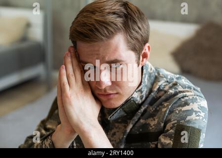 Stressed veteran soldier engrossed in depressive thoughts and memories ...