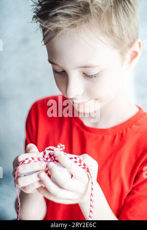 Small red wrapped gift box with ribbon and bells holiday greeting card ...