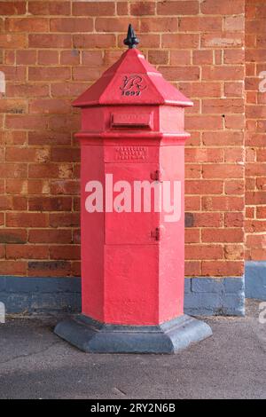 A red australia post letter box stripped of all branding and logos ...