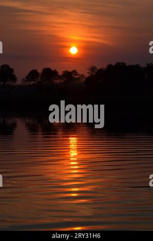 stunning sunset in the okavango river, botswana, africa Stock Photo - Alamy