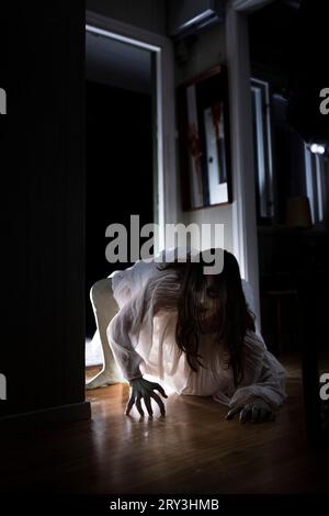 Spooky female ghost crawling in log cabin Stock Photo - Alamy