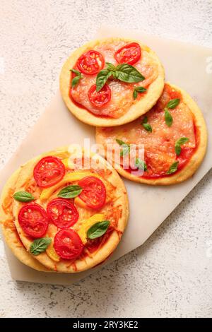 Board with different tasty mini pizzas on white background Stock Photo ...