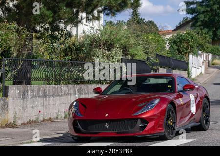 Burgundy Ferrari 812 GTS driving on the road Stock Photo - Alamy