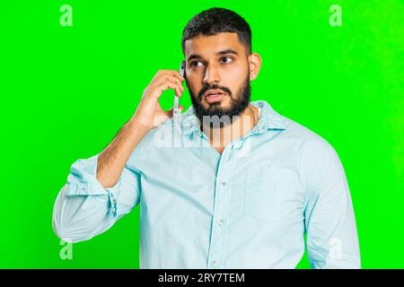 Disinterested Indian man having annoyed boring talk on smartphone ...