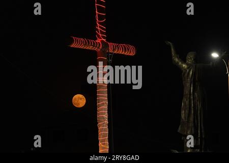 Hamdaniya, Iraq. 29th Sep, 2023. A boy lights candles outside St Mary ...