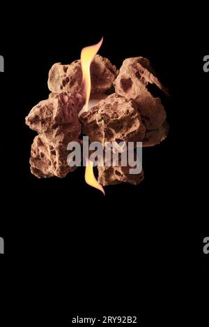 Group of colorful stones with fire flames reflected on the ground ...