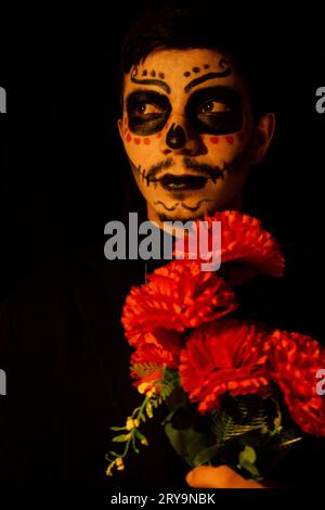 man dressed as a charro for the day of the dead next to a woman dressed ...