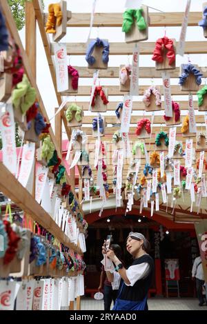Geta, traditional Japanese footwear, with strips of paper with wishes ...