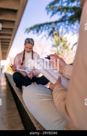 High school girl is underlining important parts in the book with a ...